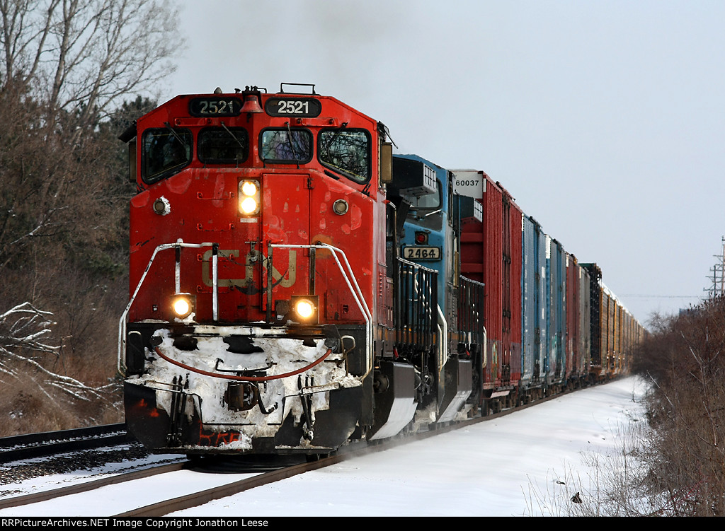 CN 2521 leads a blue IC Dash 8 west after working Flint yard